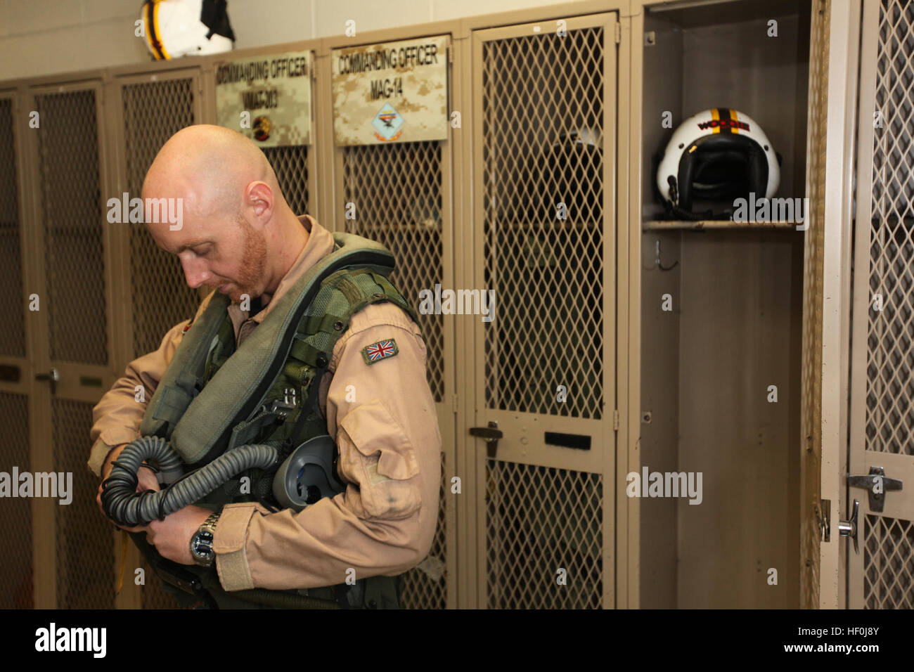 British Royal Navy Lt. Cmdr. Nathan J. Gray gets in his flight suit for ...