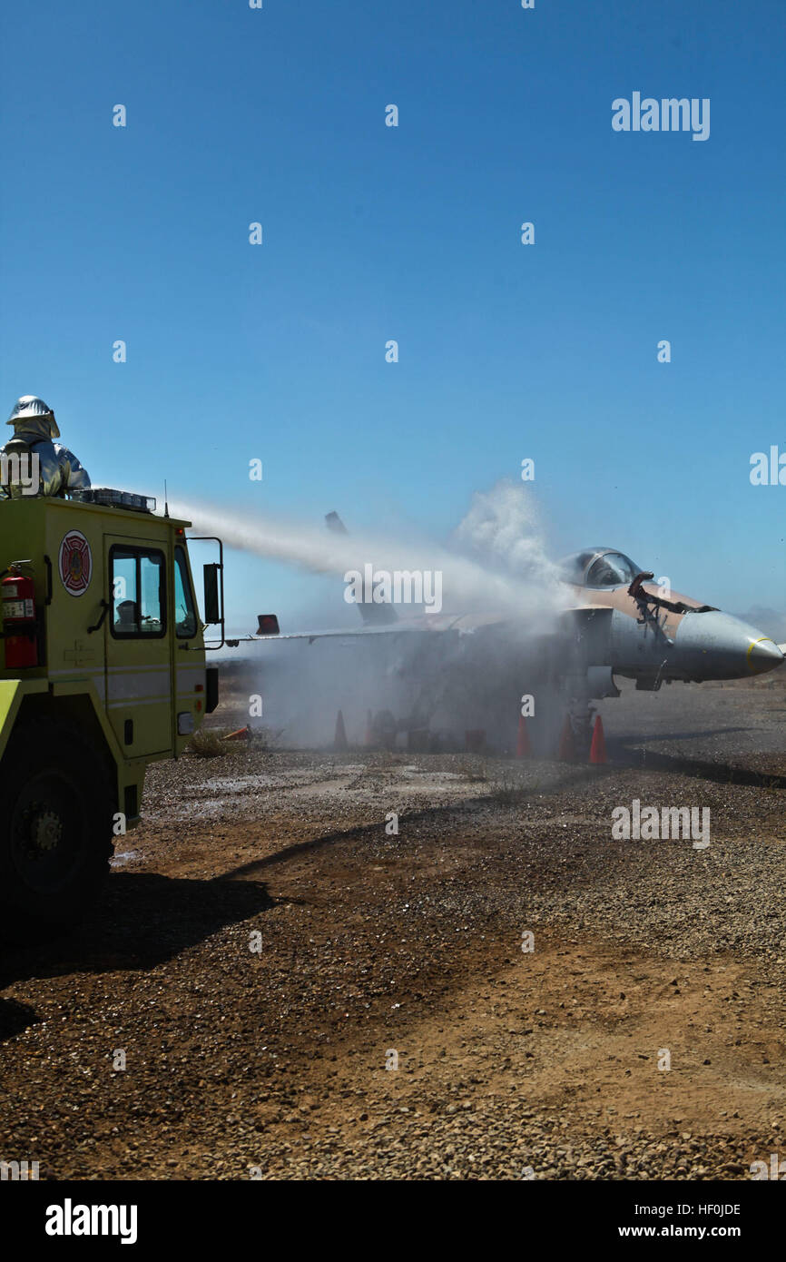 An Aircraft Rescue and Fire Fighting crewman extinguishes a simulated ...