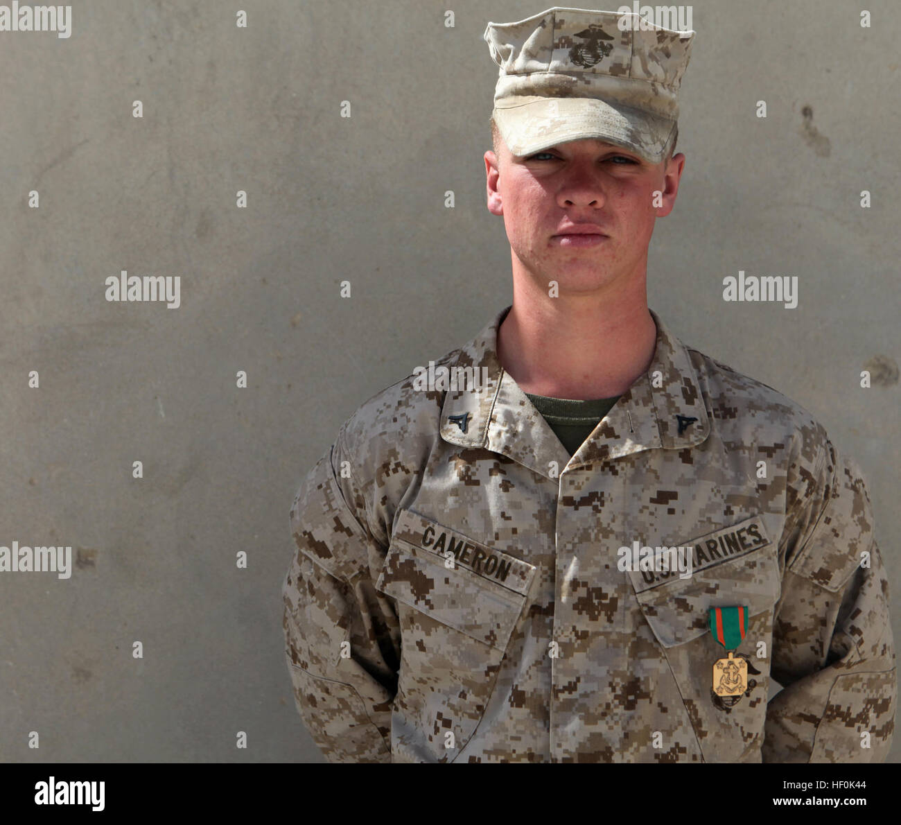 Lance Cpl. Kyle C. Cameron of Yakima, Wash., displays the Navy and ...