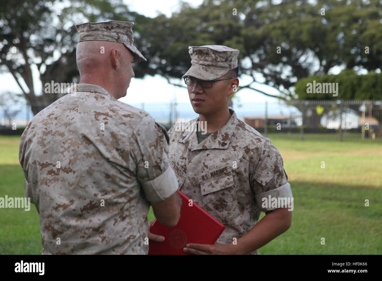 U.S. Marines Cpl. Jason Kim (right), shakes hands with Col. Brent ...