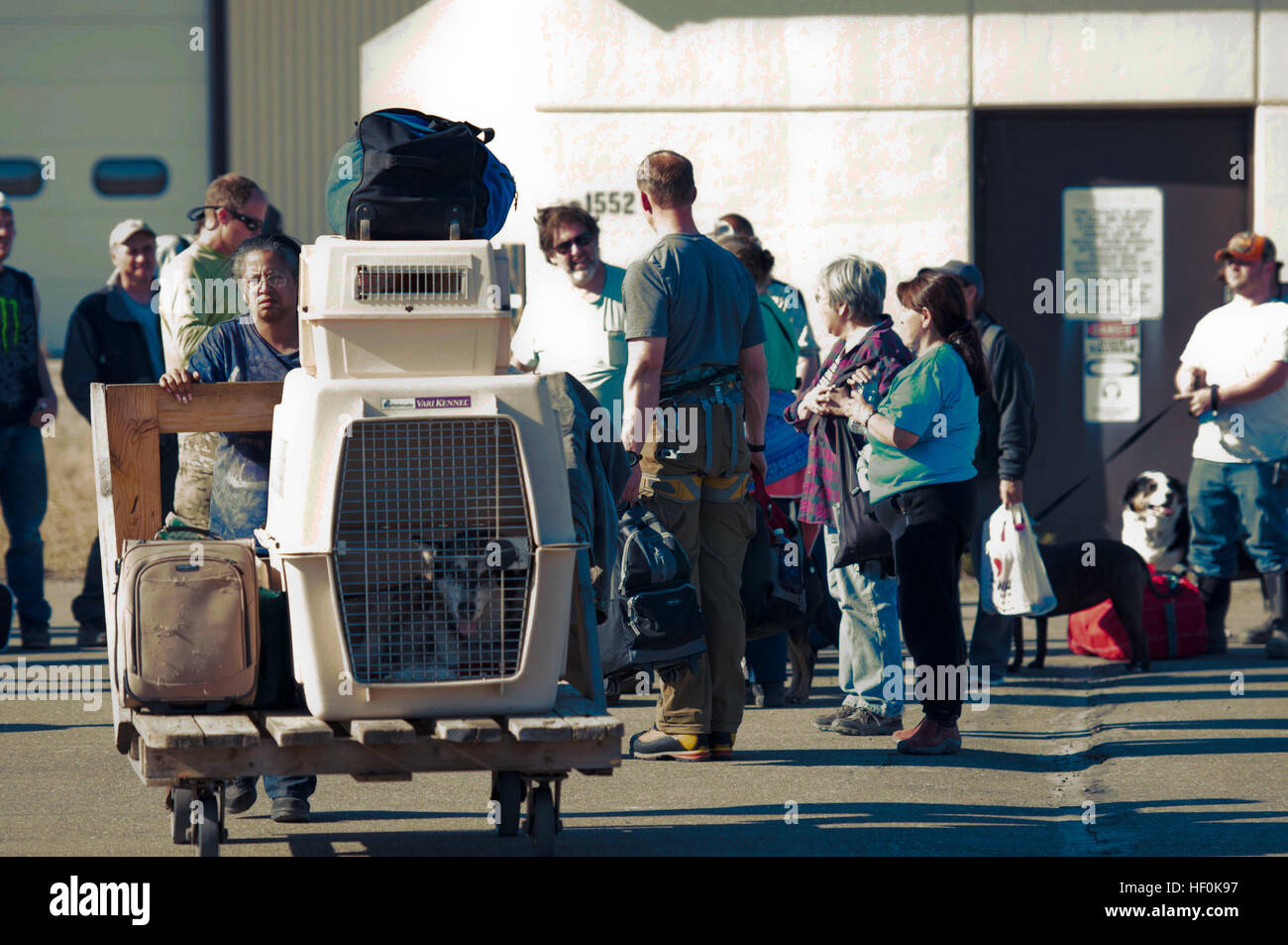 Residents of Galena, Alaska, prepare to load into a C-130 Hercules from ...