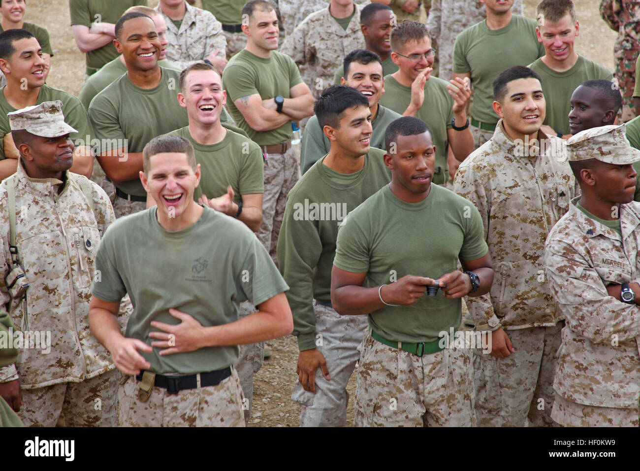 The crowd of onlookers laugh as their fellow service members compete in ...