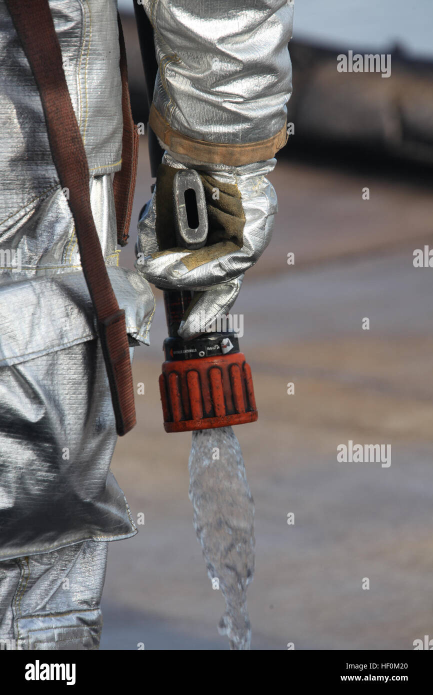An Aircraft Rescue Firefighting Marine tests his hand line nozzle to ...