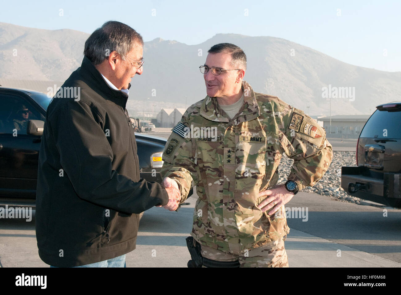 U.S. Secretary of Defense Leon Panetta shakes hands with the commander ...