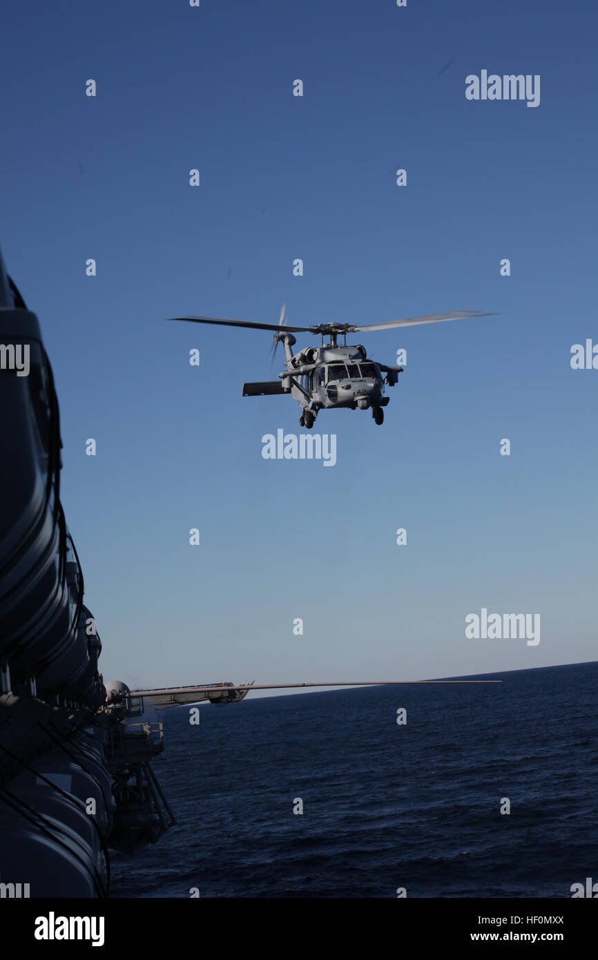 A Navy SH-60 Seahawk helicopter practices lifting off and landing from ...