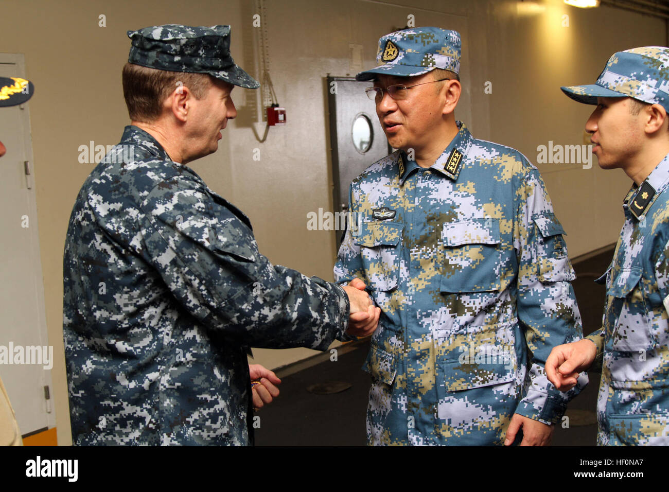 U.S. Navy Capt. John Gilman, Theater Security Cooperation officer in charge, shakes the hand of ...