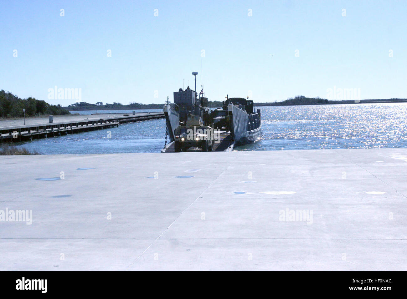 A Landing Craft Utility transport boat unloads Marines and their ...