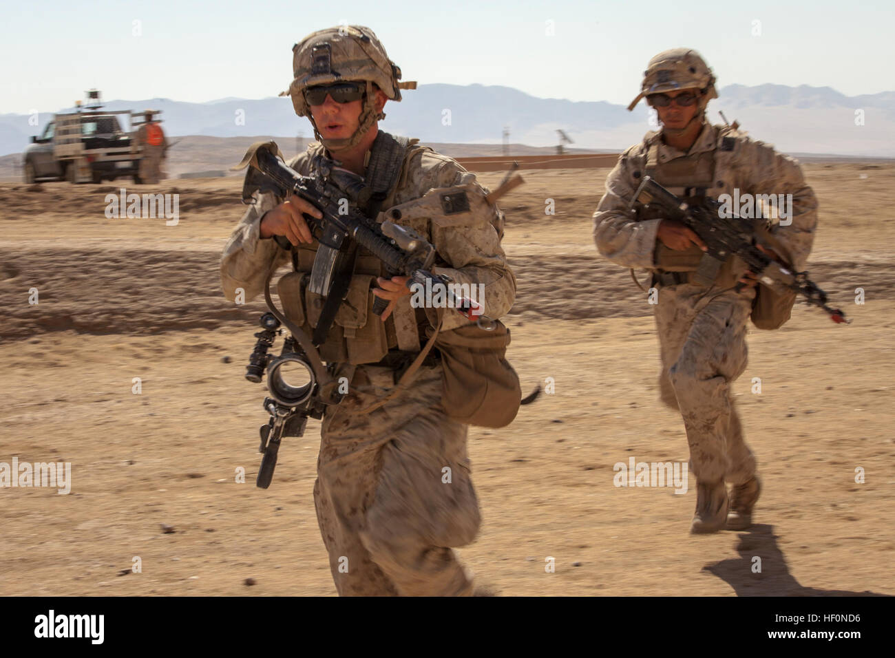Marines with 3rd Battalion, 7th Marine Regiment, run to cover at Range ...