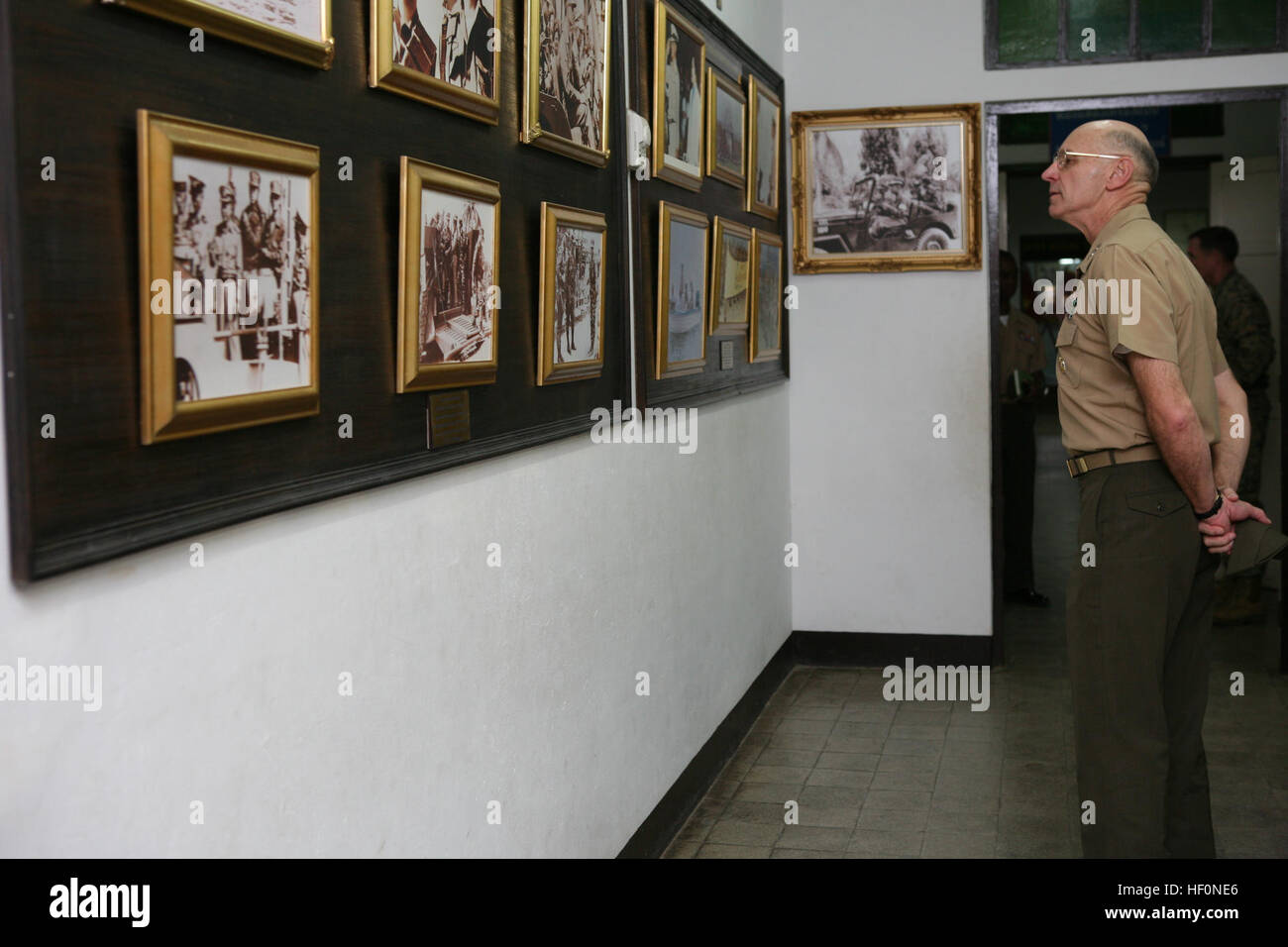 Lt. Gen. Duane D. Thiessen looks at photos on display at the Royal Thai ...