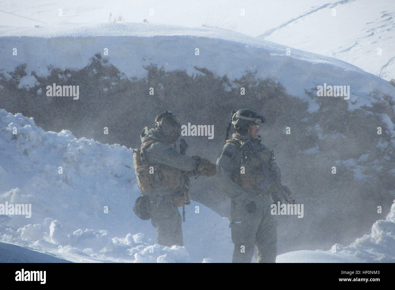 Two U.S. Special Operations Forces personnel watch an ISAF helicopter ...