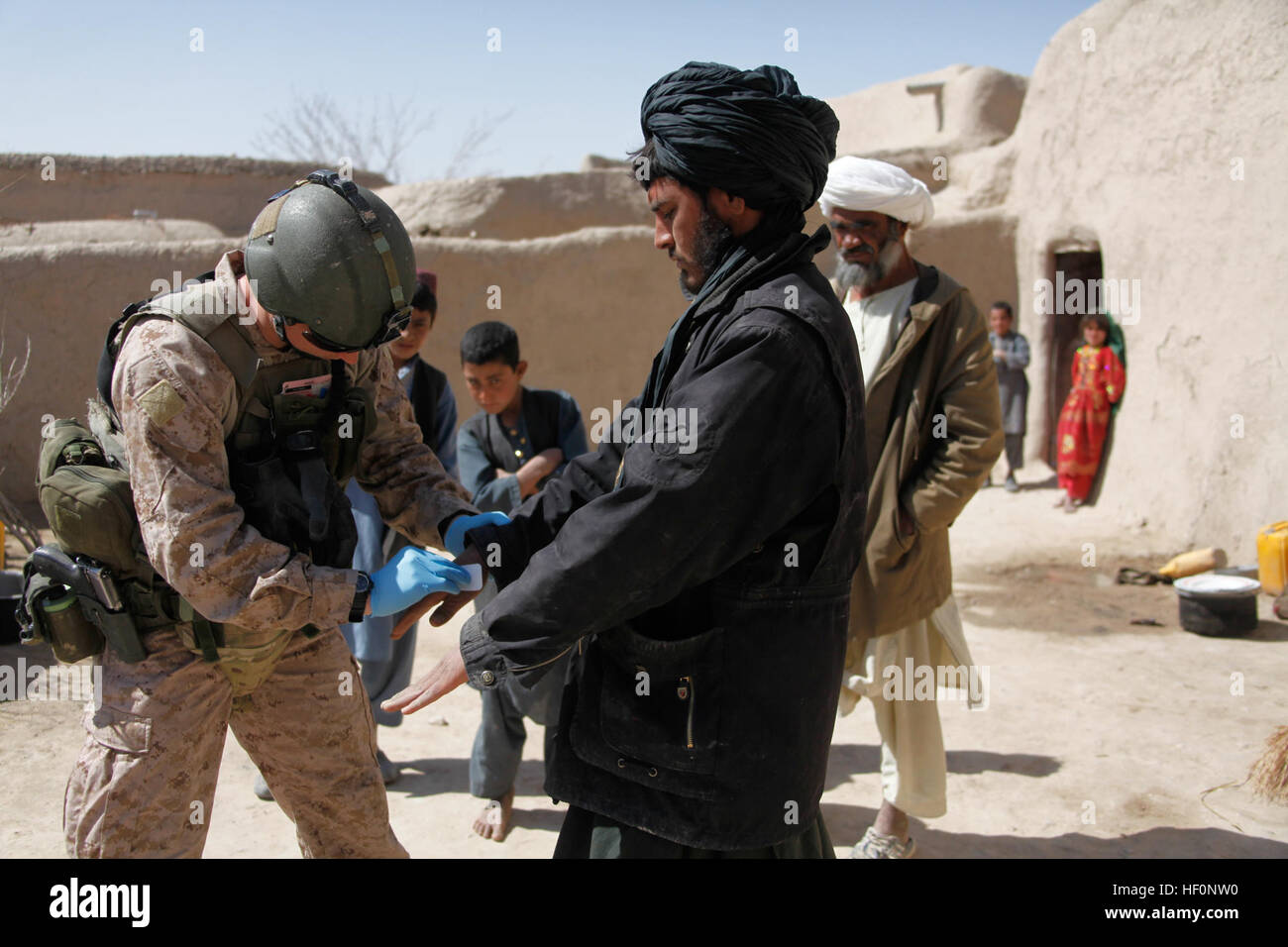 British Royal Marine Commando Lance Cpl. Alan Cahill, left, wipes the ...