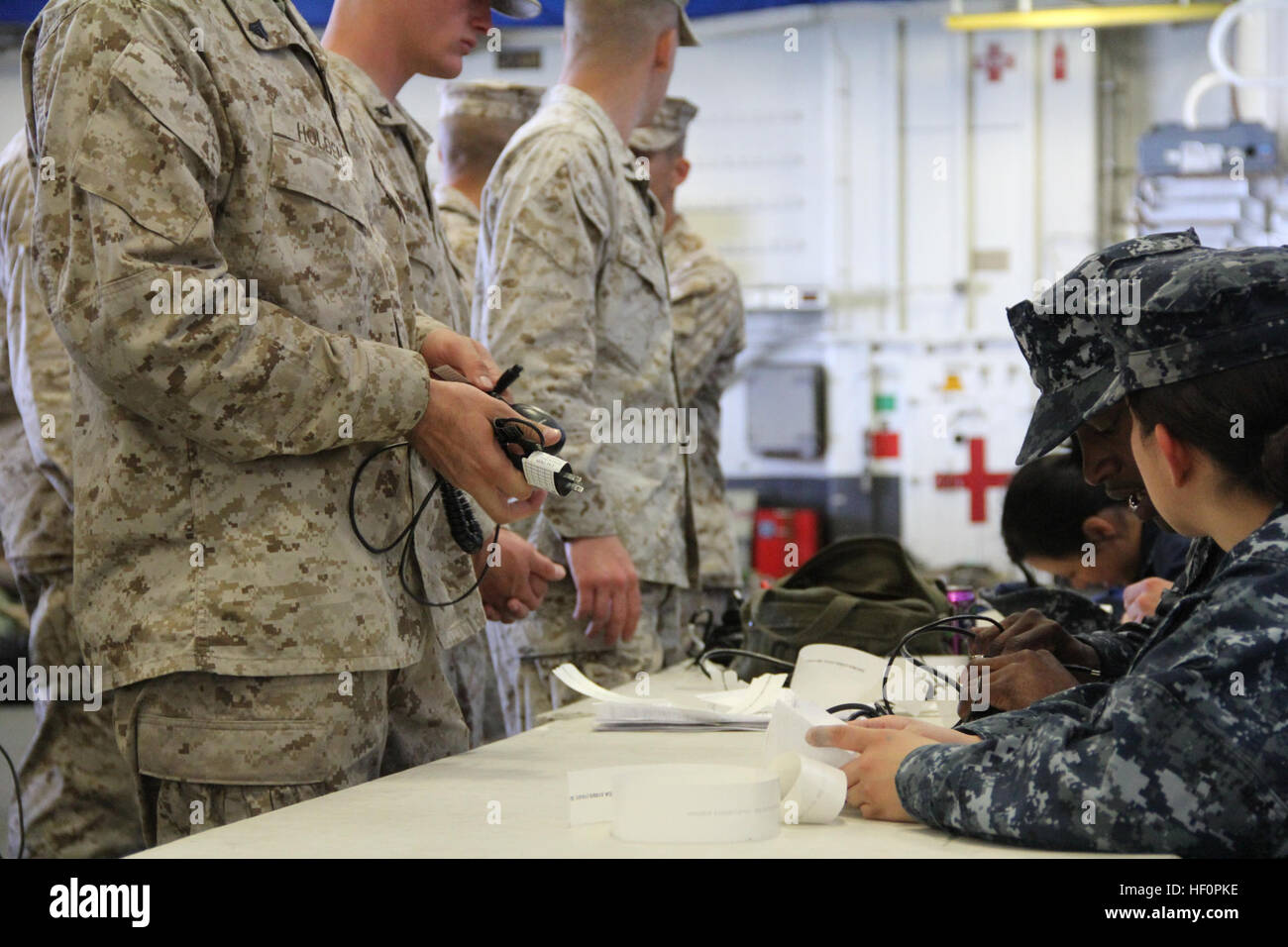 Sailors aboard the USS Wasp check the plugs for the Marines' personal ...