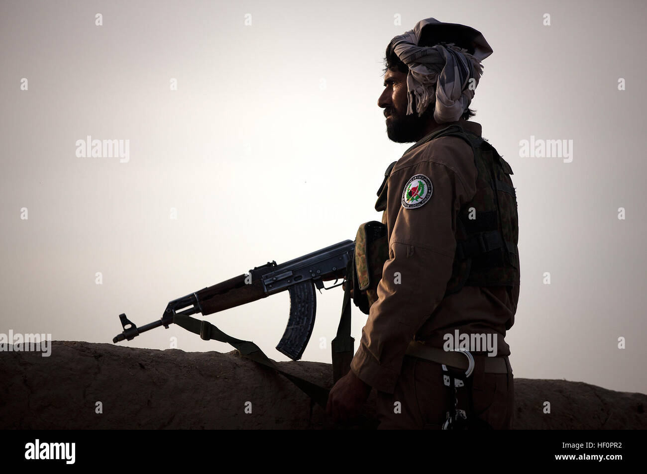 Afghan Local Policeman Abdul Salaam provides security along the edge of ...