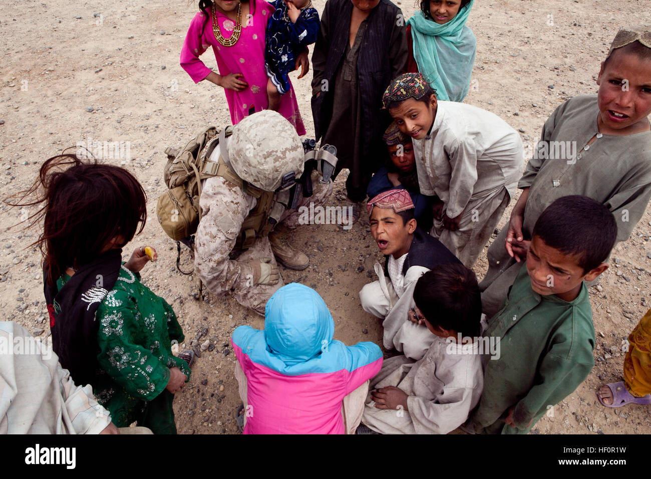 Local Afghan children gather around U.S. Marine Cpl. Genesis L. Nanez ...
