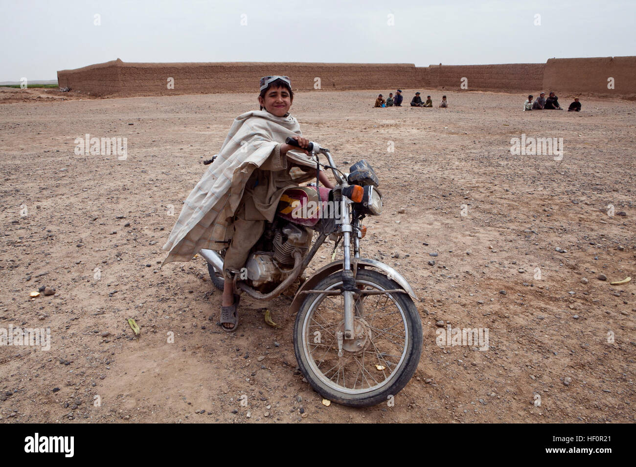 An Afghan boy poses on his motorcycle during a shura in Sheik Abad ...