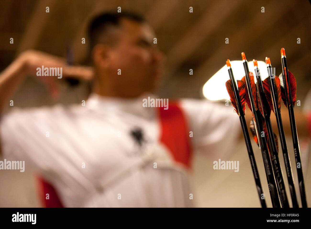 Sgt. Than Naing, native of New York, releases the string of his recurve ...