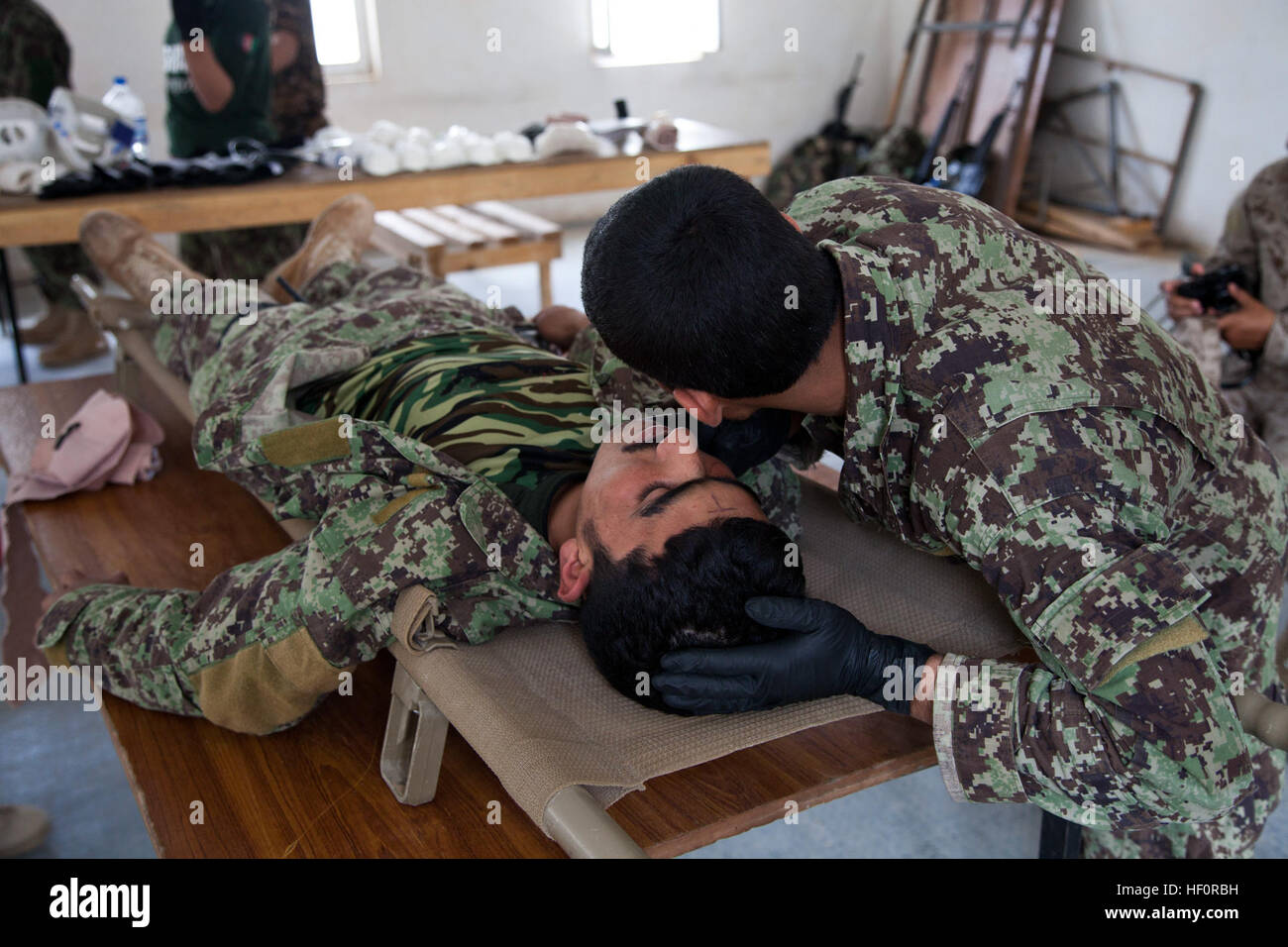 CAMP GARMSIR, Afghanistan - An Afghan National Army soldier checks the ...