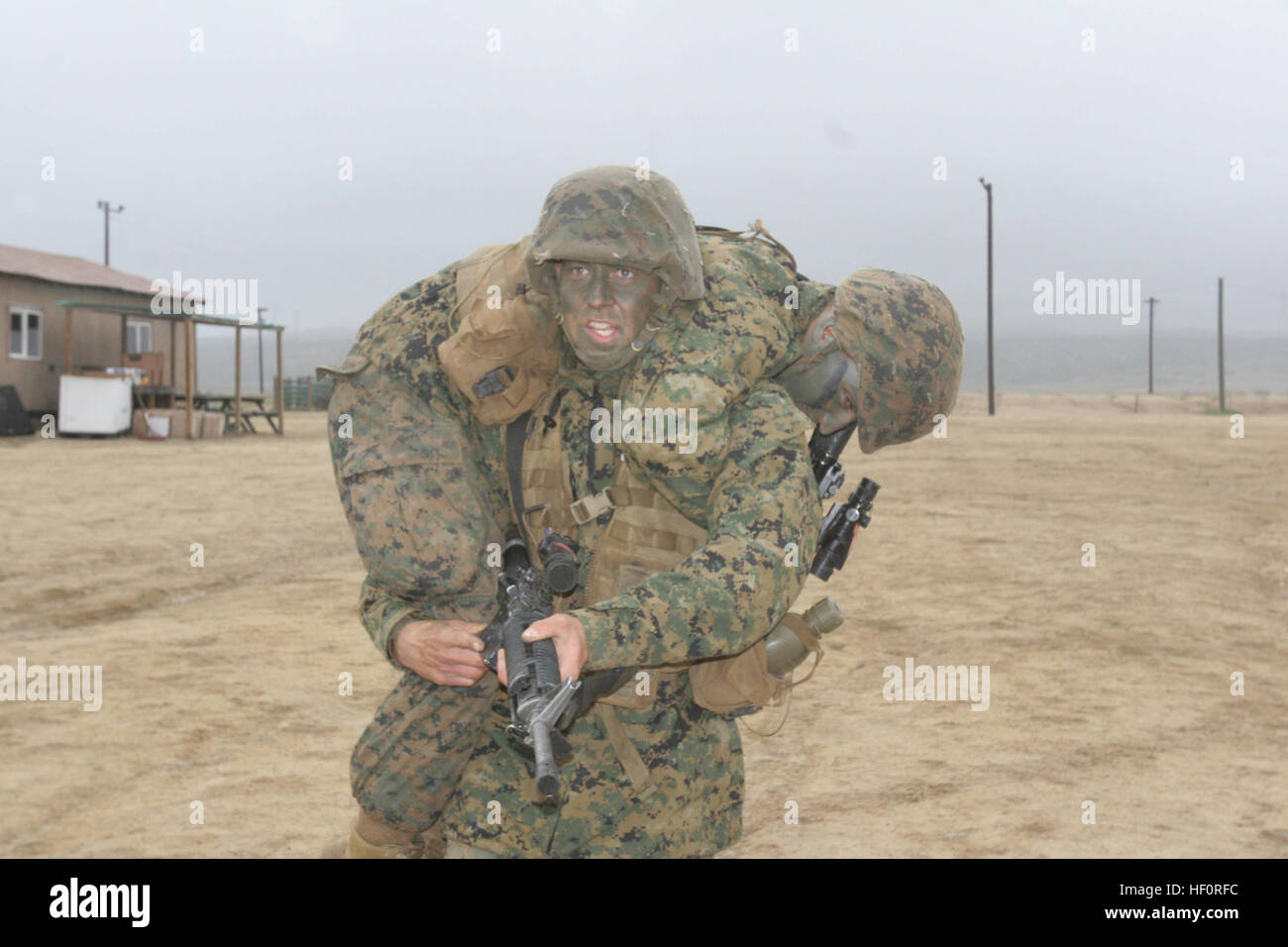 A Marine Corps recruit performs a fireman’s carry during the Crucible ...