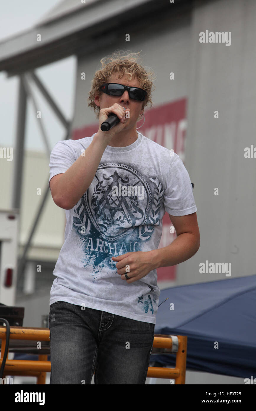 David Kroll, a country music artist, sings for people in attendance at ...