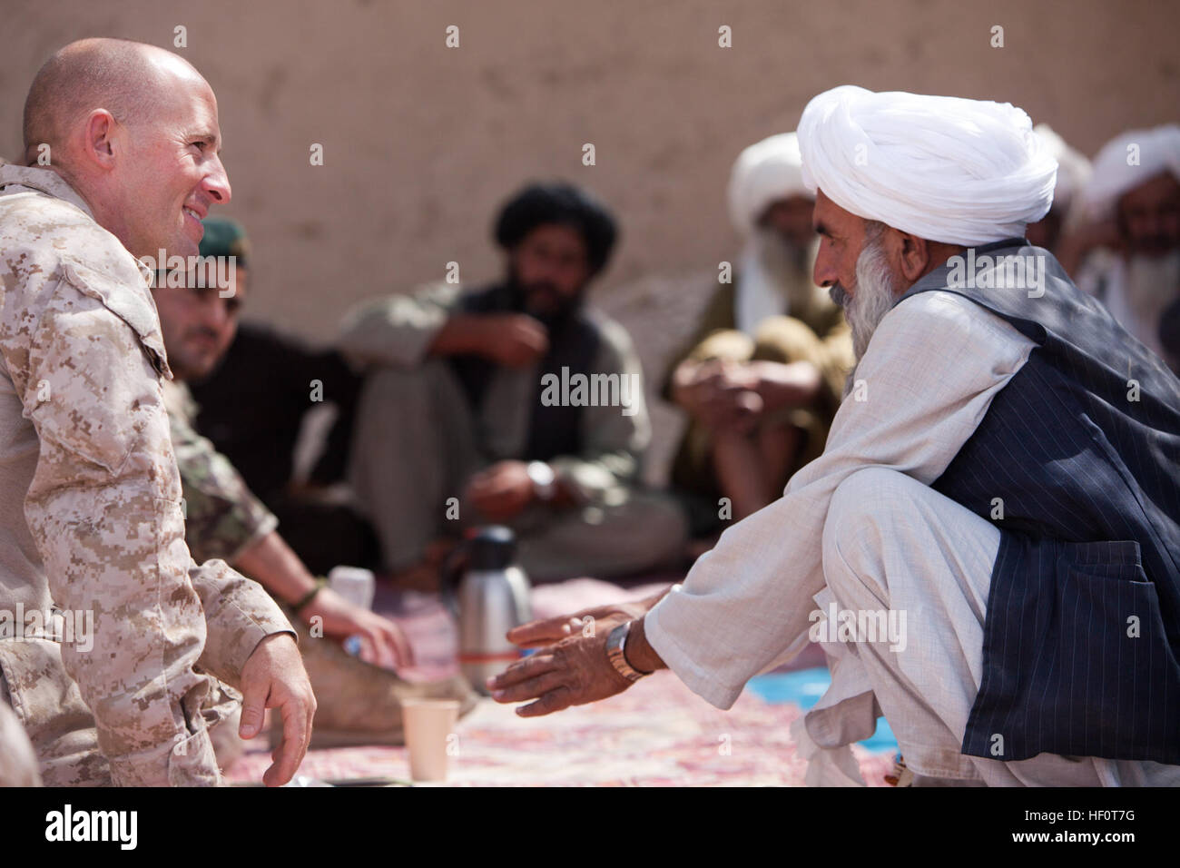 Speaks with an afghan civilian during a shura hi-res stock photography ...