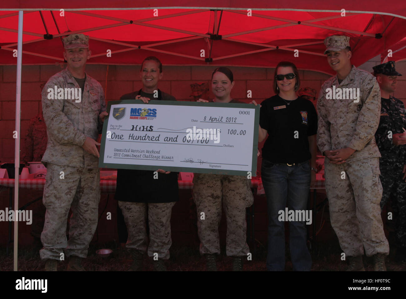 Marine Corps Community Services presents a $100 check to Lt. Col ...
