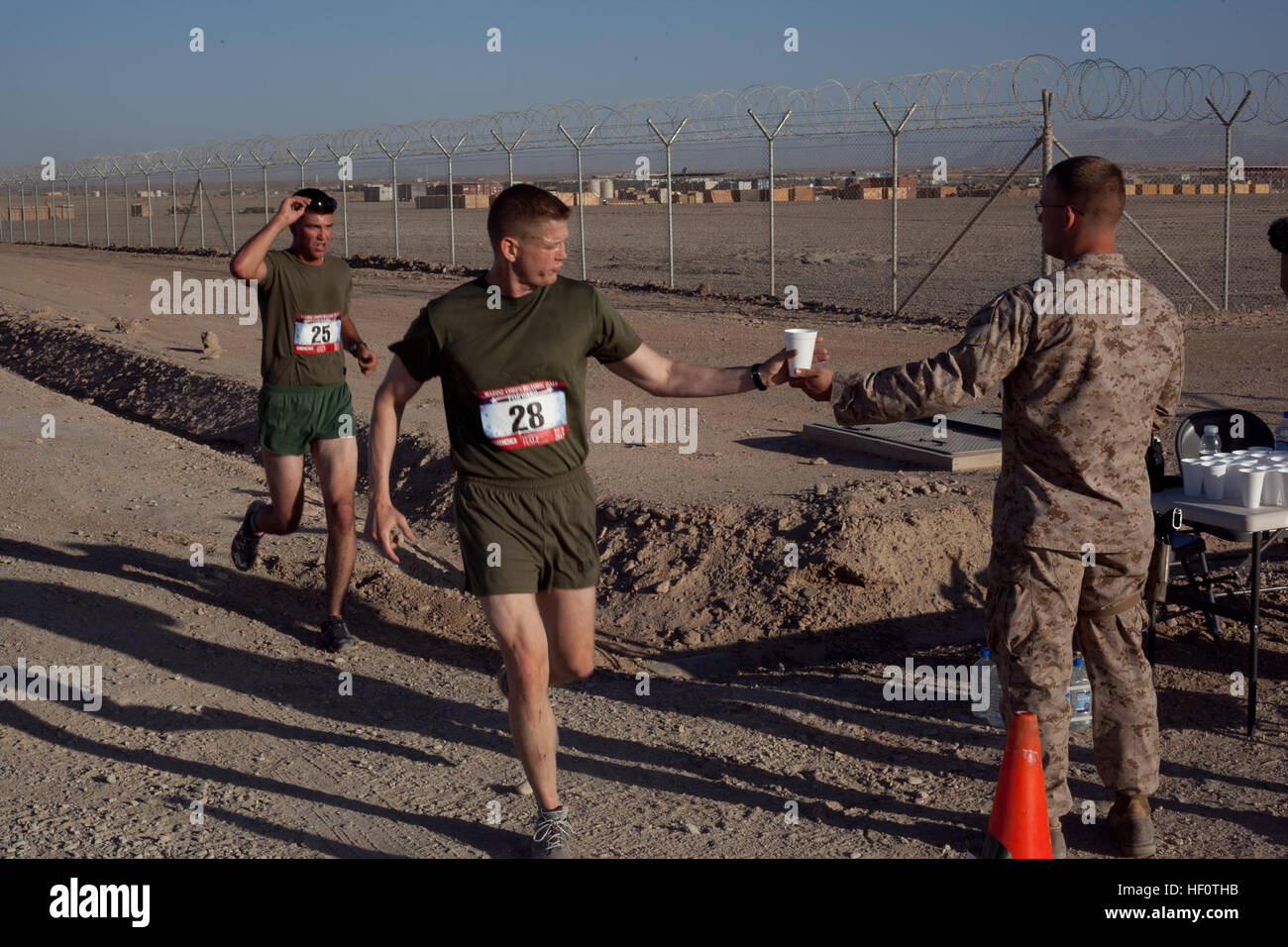 Major Christopher Brannen grabs a cup of water as Lance Cpl. Arthur ...