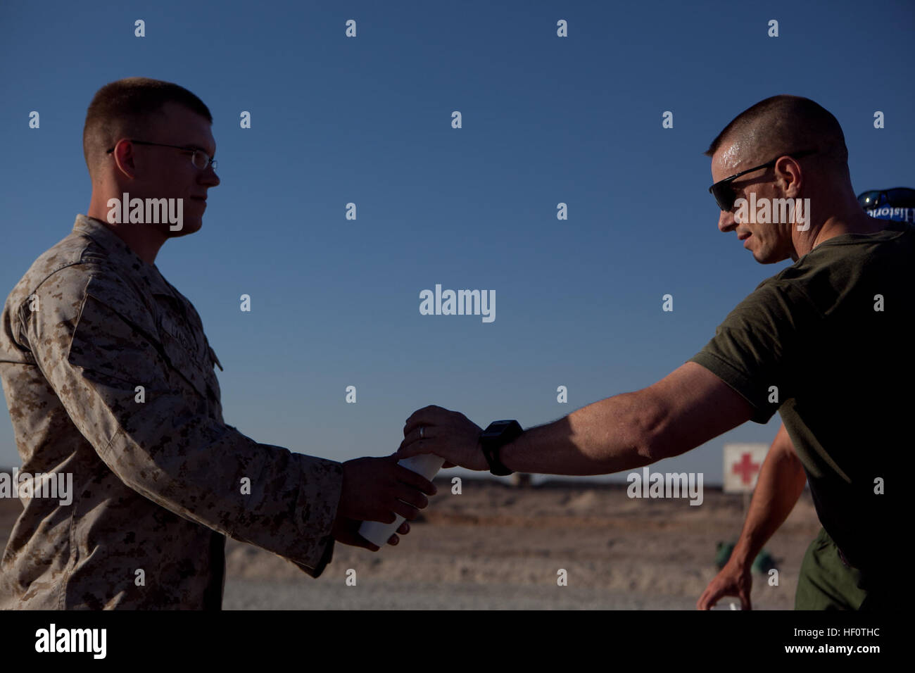 Major Andrew McNulty grabs a cup of water from Lance Cpl. Randy Langdon ...