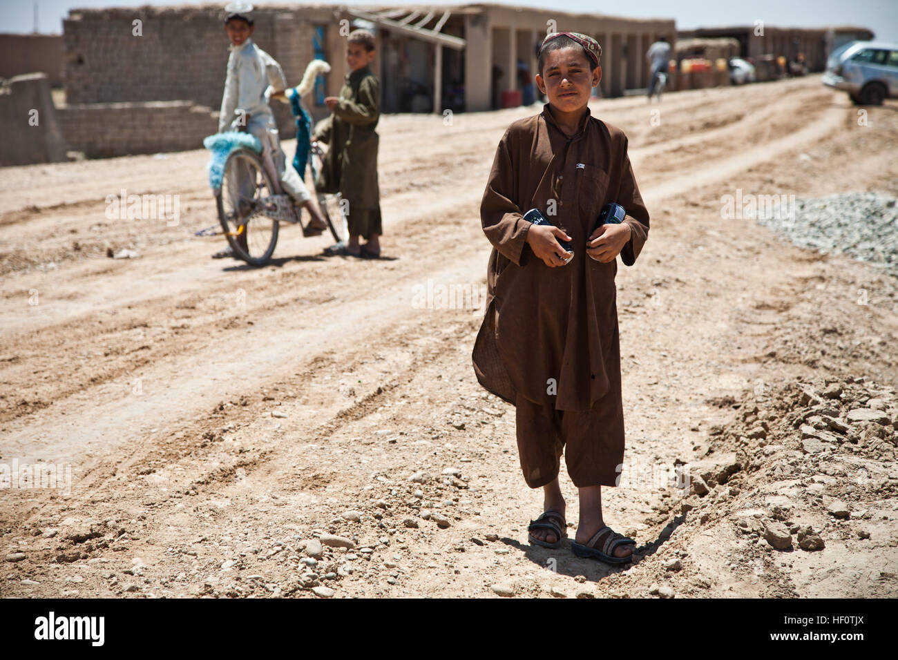 An Afghan boy watches as U.S. Marines with Regimental Combat Team 5 ...