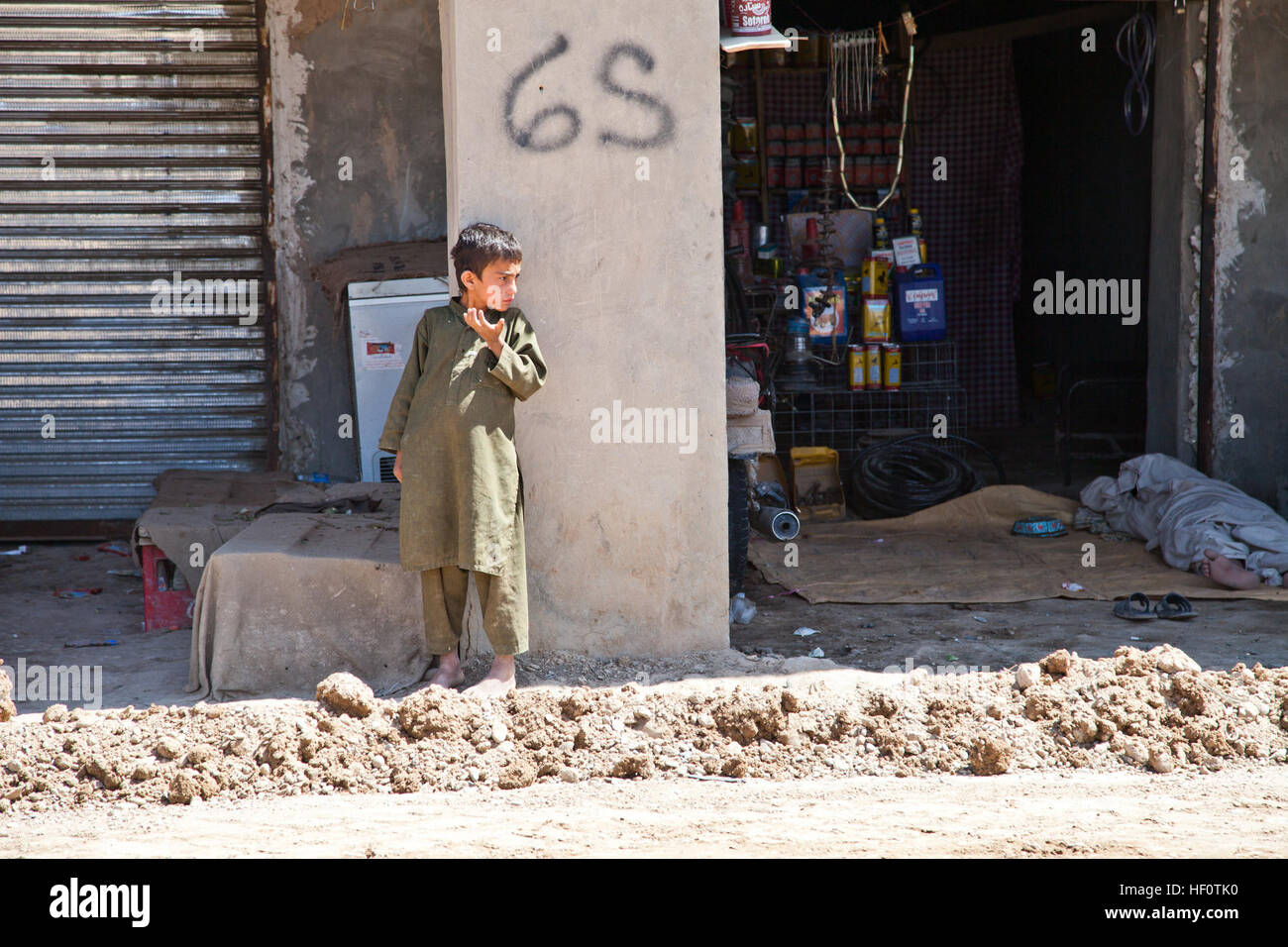 A local Afghan boy looks on as U.S. Marines with Regimental Combat Team ...