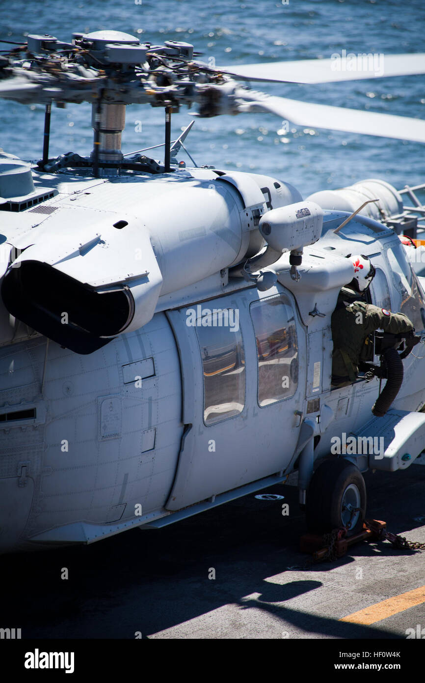 U.S. Navy SH-60 Sea Knight sits on the flight deck of the USS Peleliu ...