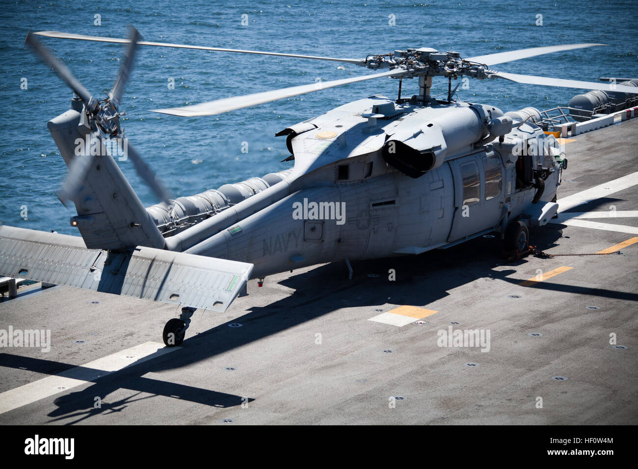 U.S. Navy SH-60 Sea Knight sits on the flight deck of the USS Peleliu ...