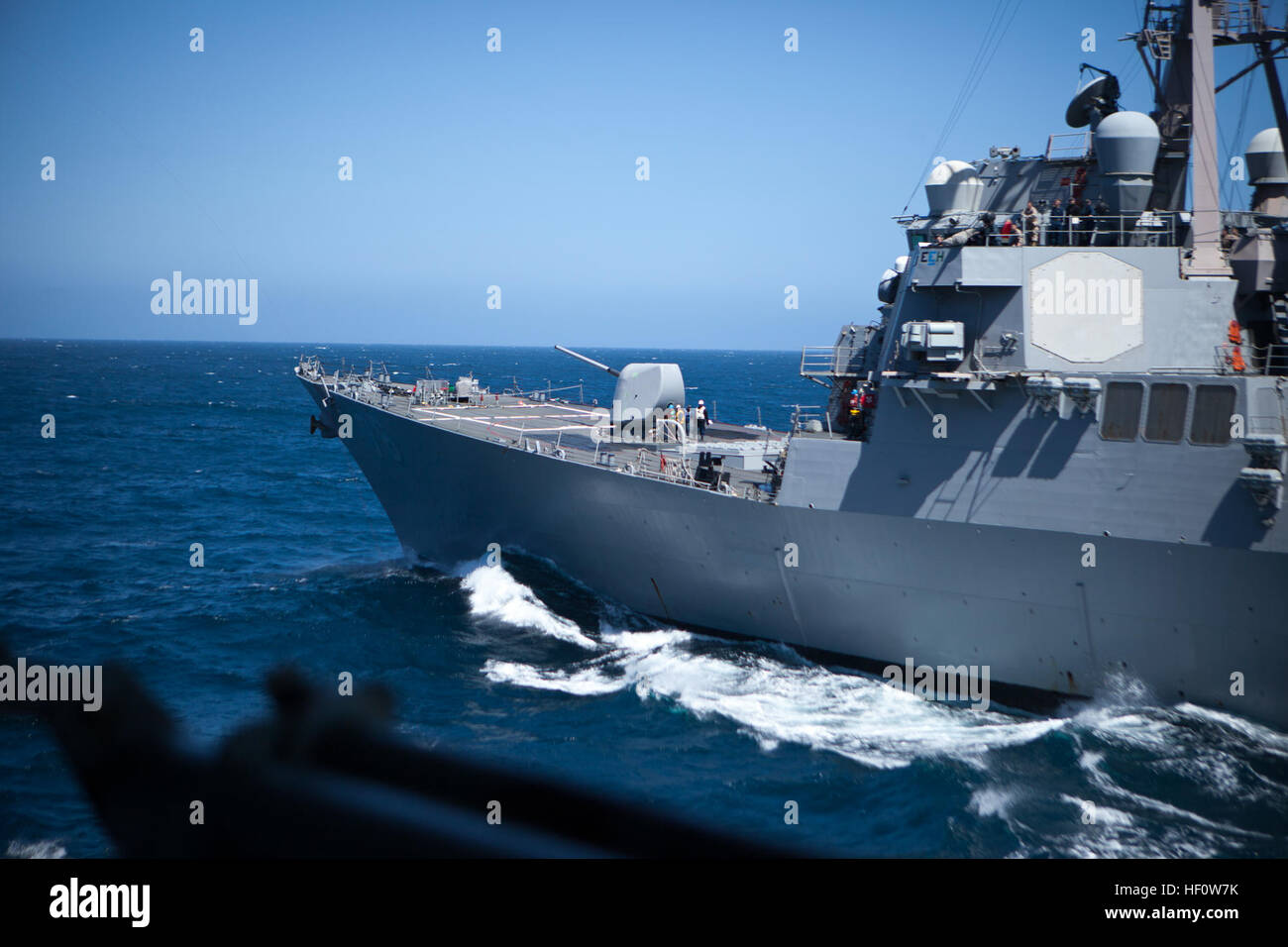U.S. Naval Ship USS Harris floats by the USS Peleliu during a ship to ...