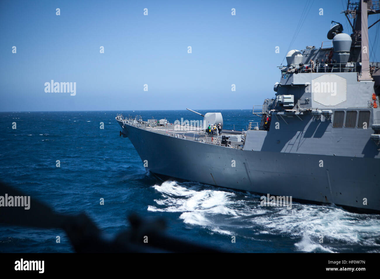 U.S. Naval Ship USS Harris floats by the USS Peleliu during a ship to ...