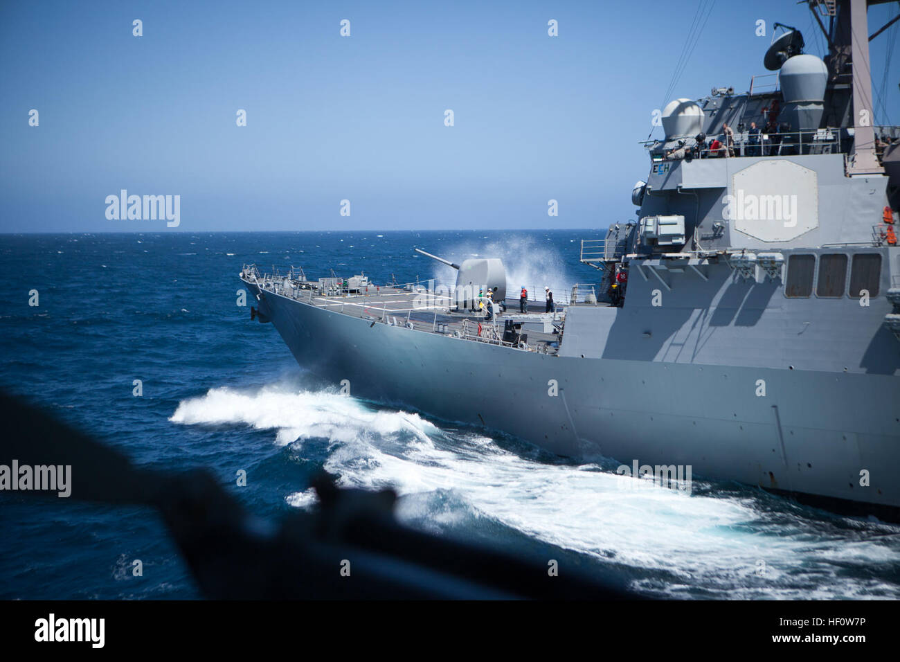 U.S. Naval Ship USS Harris floats by the USS Peleliu during a ship to ...