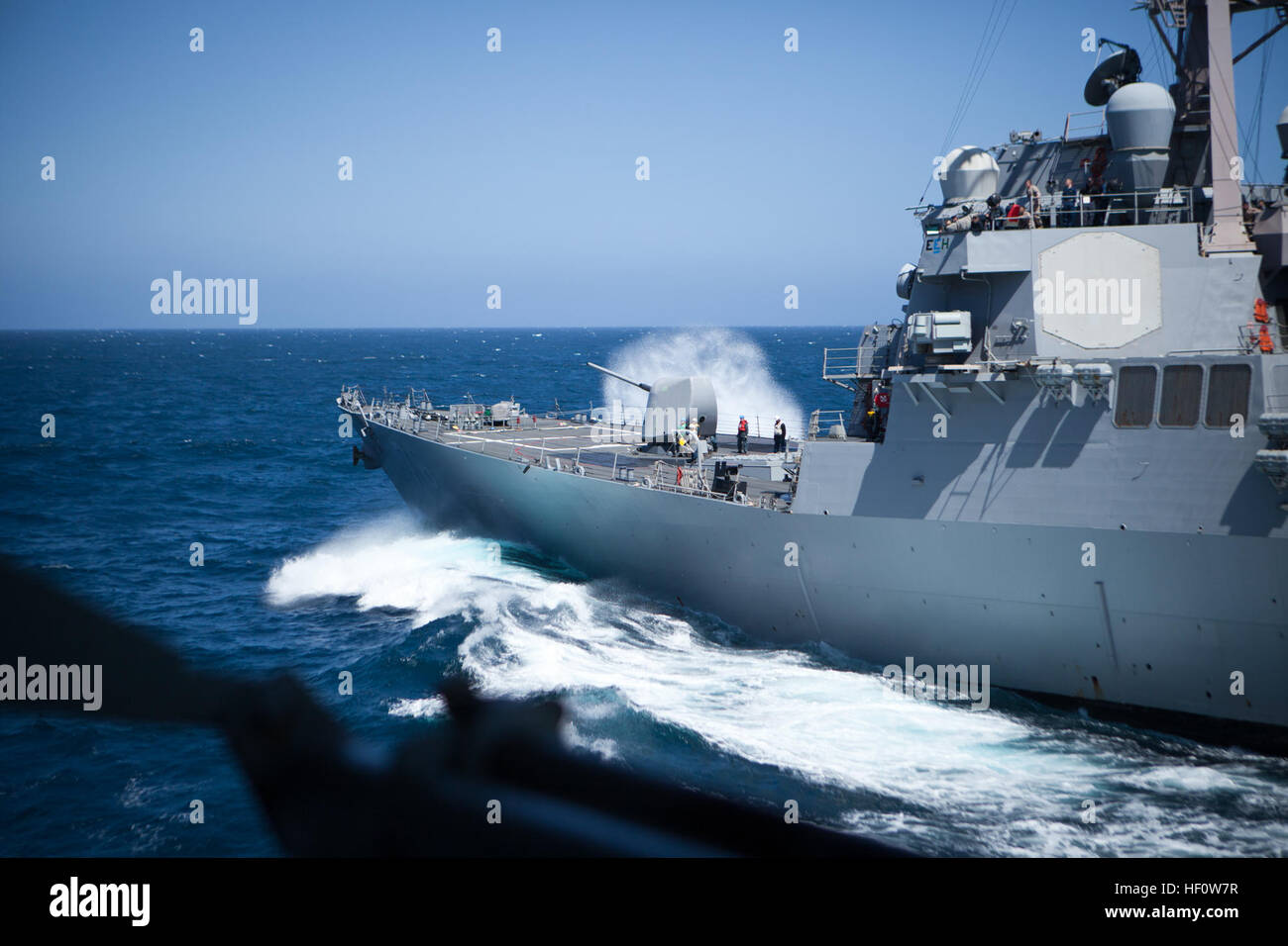 U.S. Naval Ship USS Harris floats by the USS Peleliu during a ship to ...