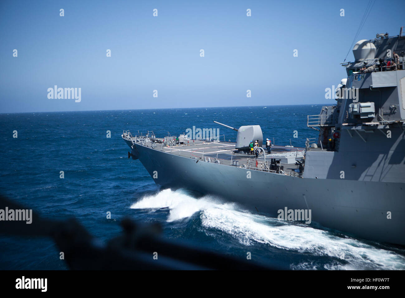 U.S. Naval Ship USS Harris floats by the USS Peleliu during a ship to ...