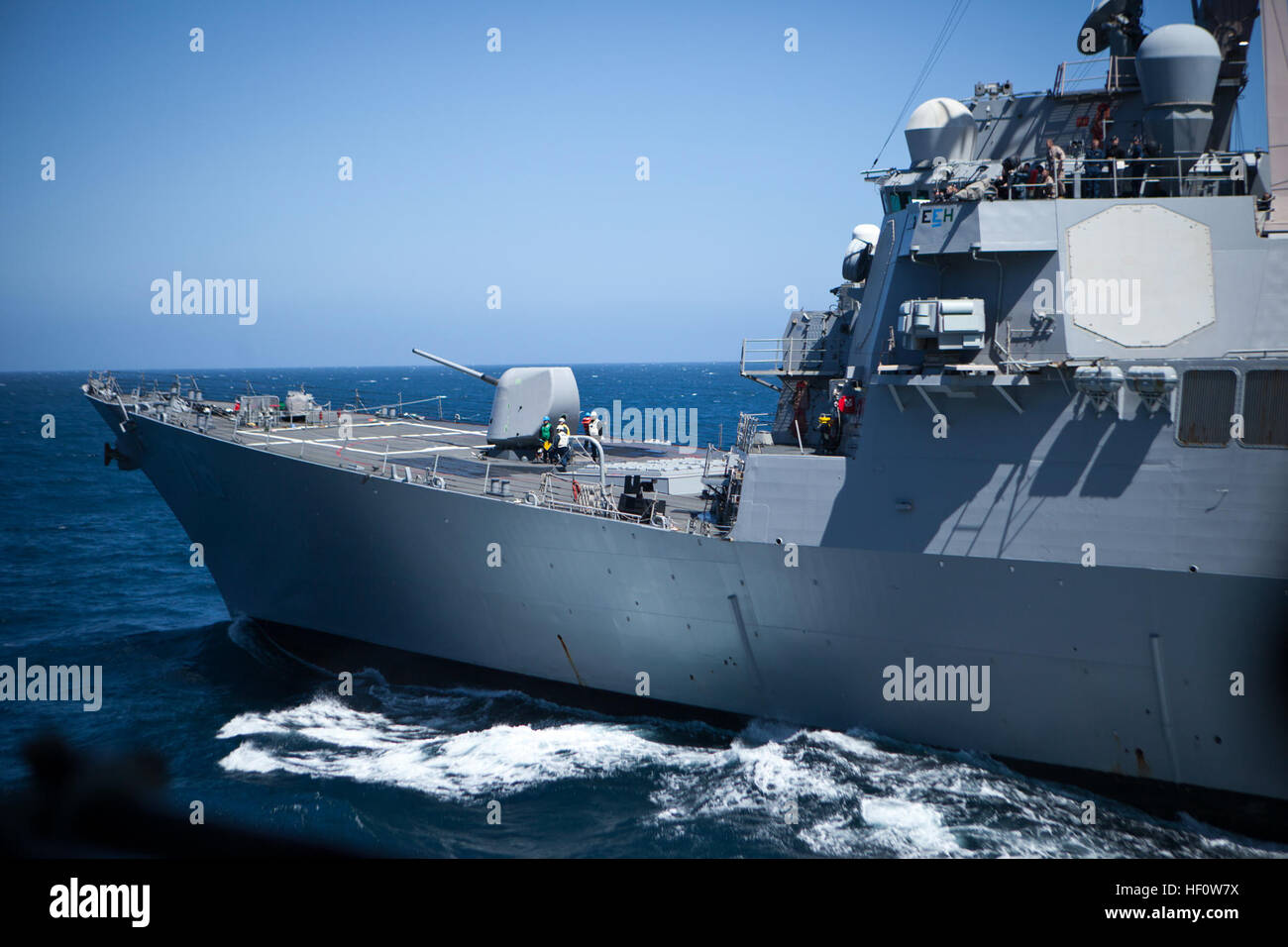 U.S. Naval Ship USS Harris floats by the USS Peleliu during a ship to ...