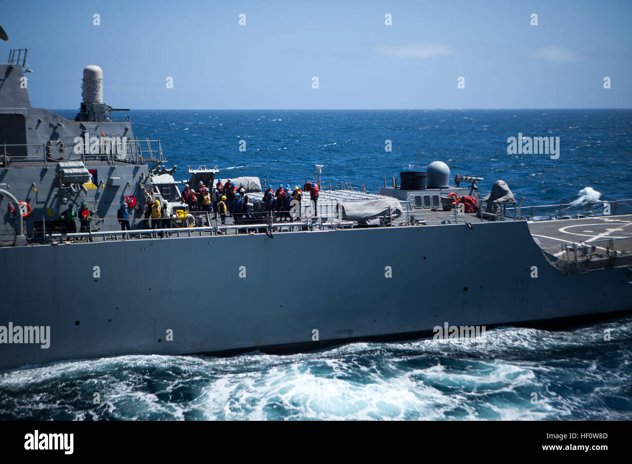 U.S. Naval Ship USS Harris floats by the USS Peleliu during a ship to ...