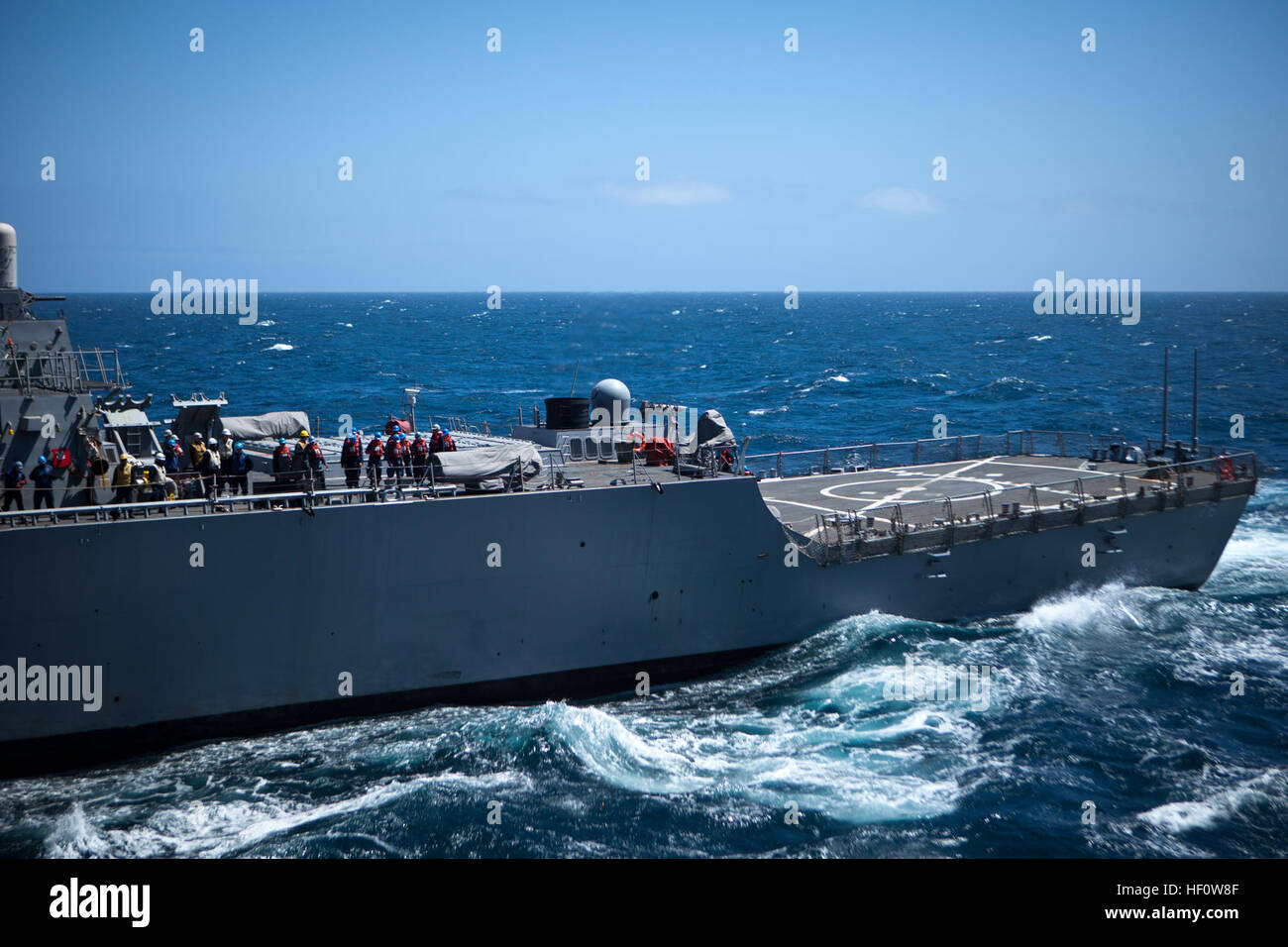 U.S. Naval Ship USS Harris floats by the USS Peleliu during a ship to ...