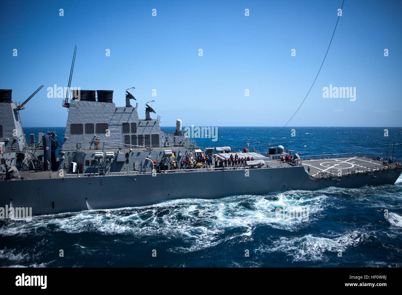 U.S. Naval Ship USS Harris floats by the USS Peleliu during a ship to ...