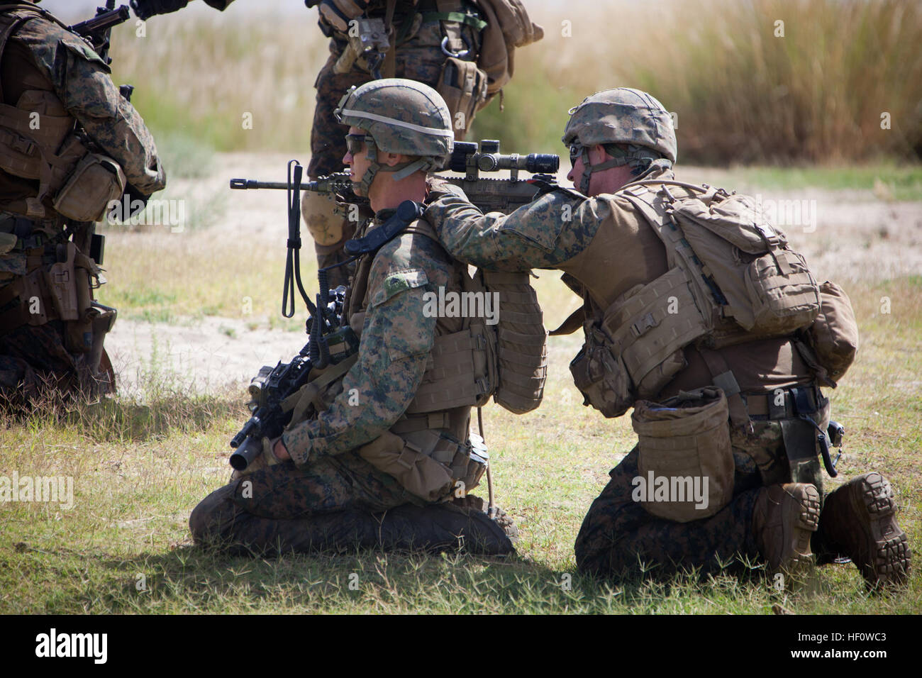 U.S. Marine Corps Cpl. Louis Wood, left, team leader, provides his ...
