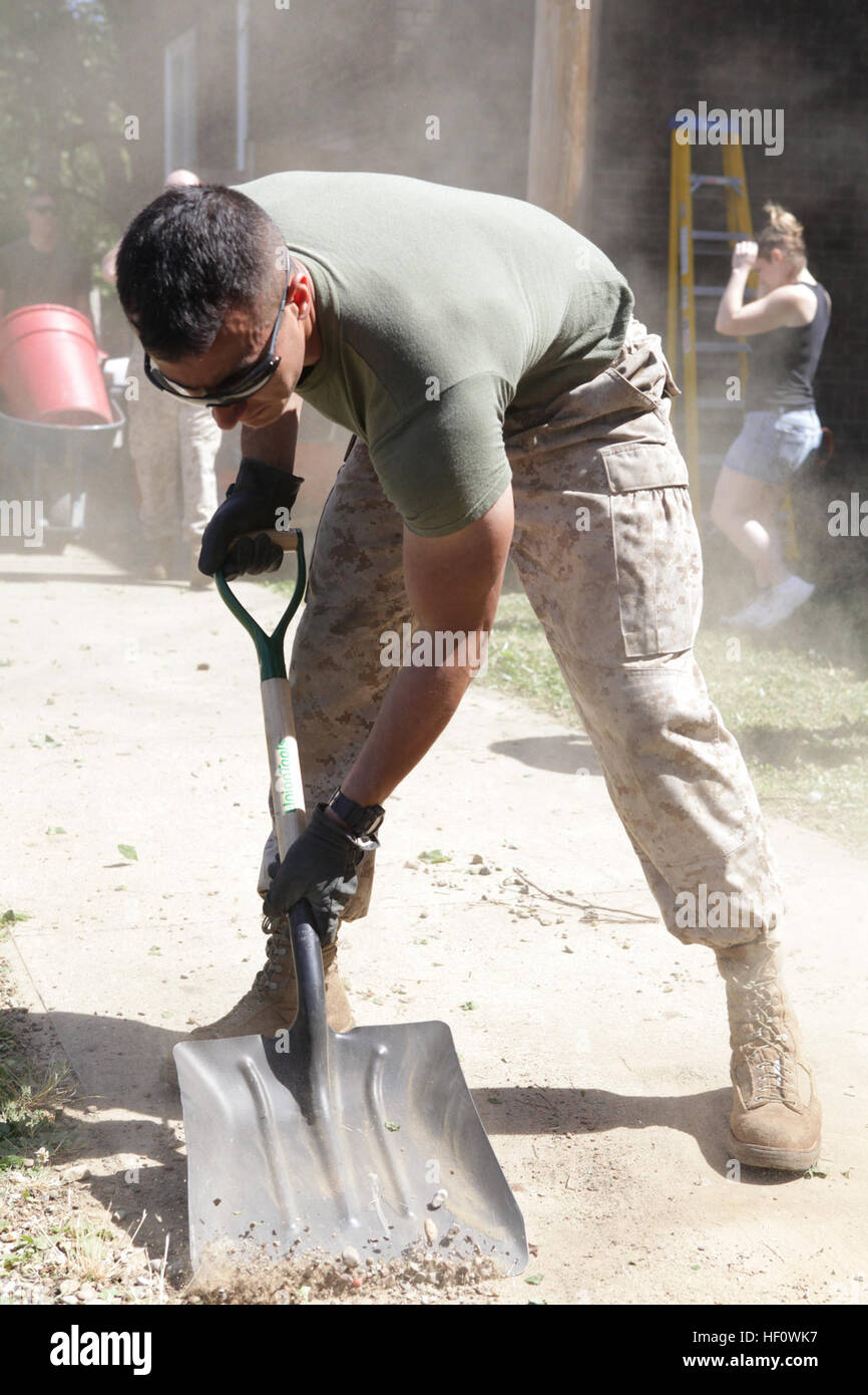 Lance Cpl. Andrew P. Reda, 3rd Battalion, 25th Marine Regiment, shovels ...