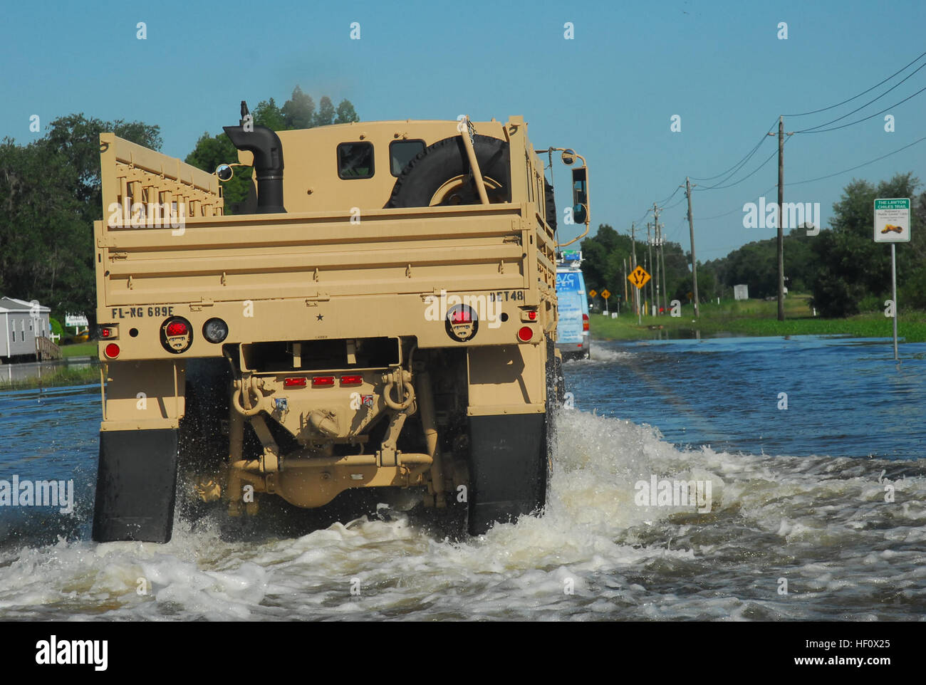 Soldiers from the Florida National Guard use a high-water vehicle to ...
