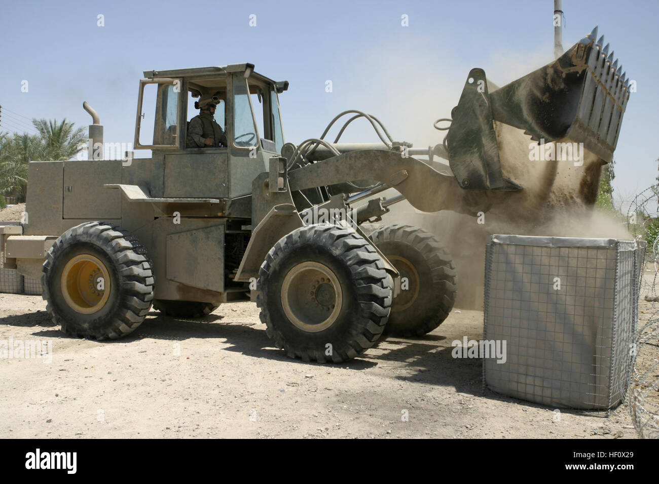 A Marine from 2nd Combat Engineer Battalion fortifies an Iraqi base of ...