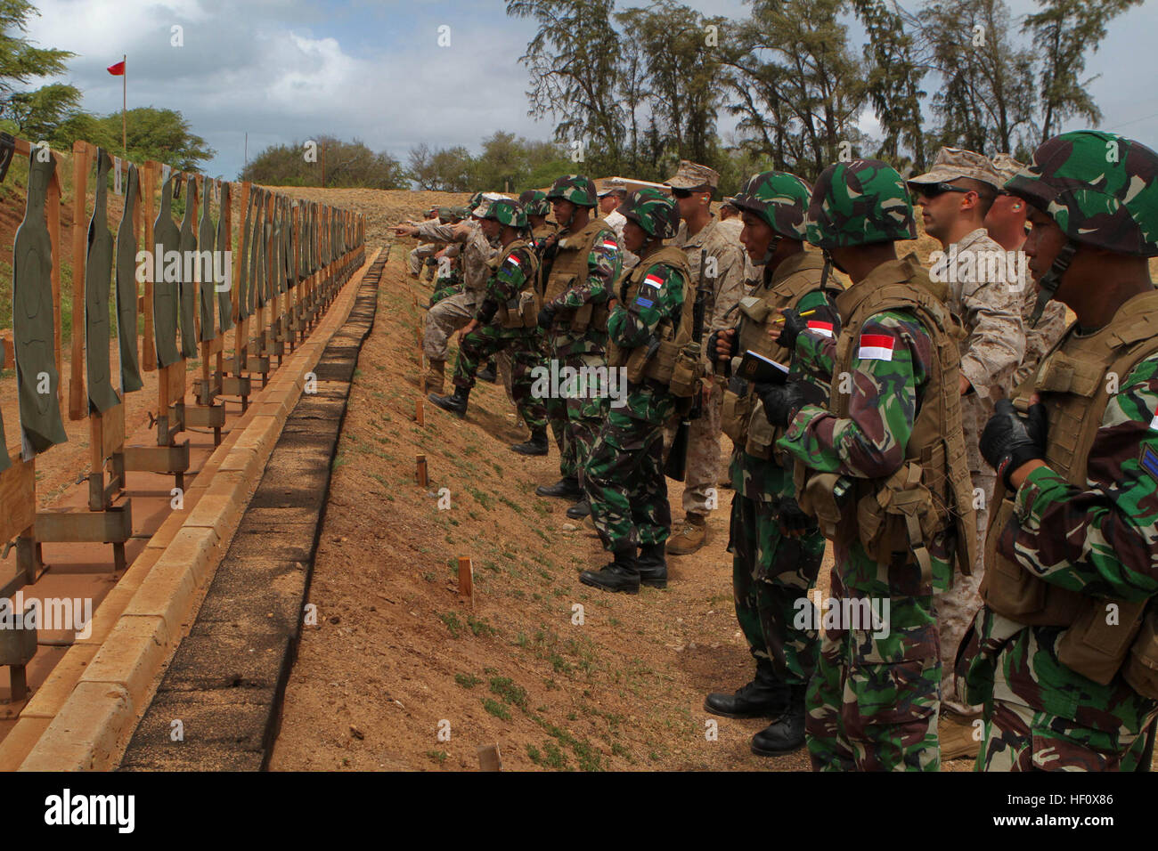 Indonesian Marines observe their 25-meter rifle impacts during a ...