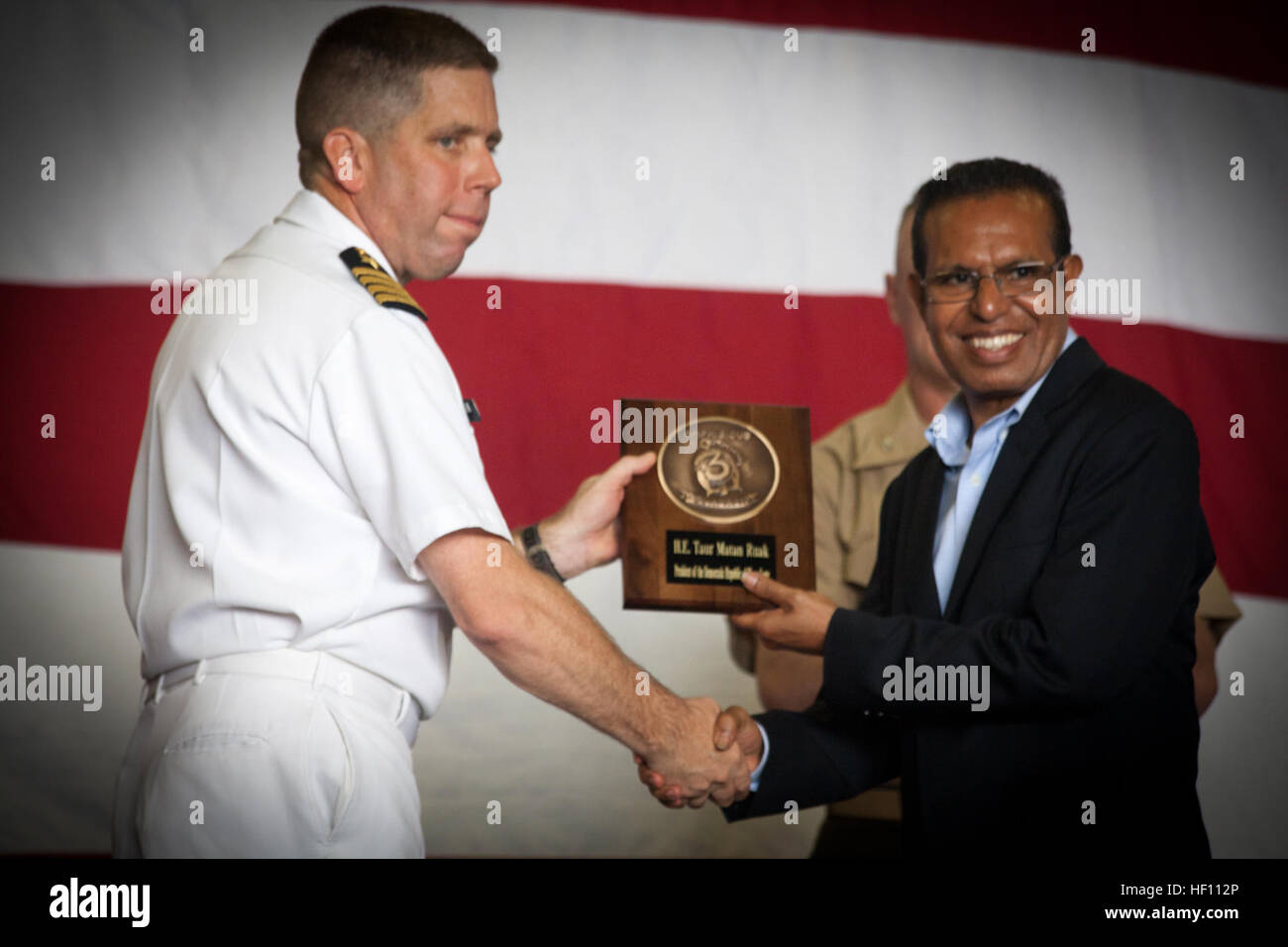 U.S. Navy Capt. Mark Sakaguchi, left, the commander of Amphibious ...
