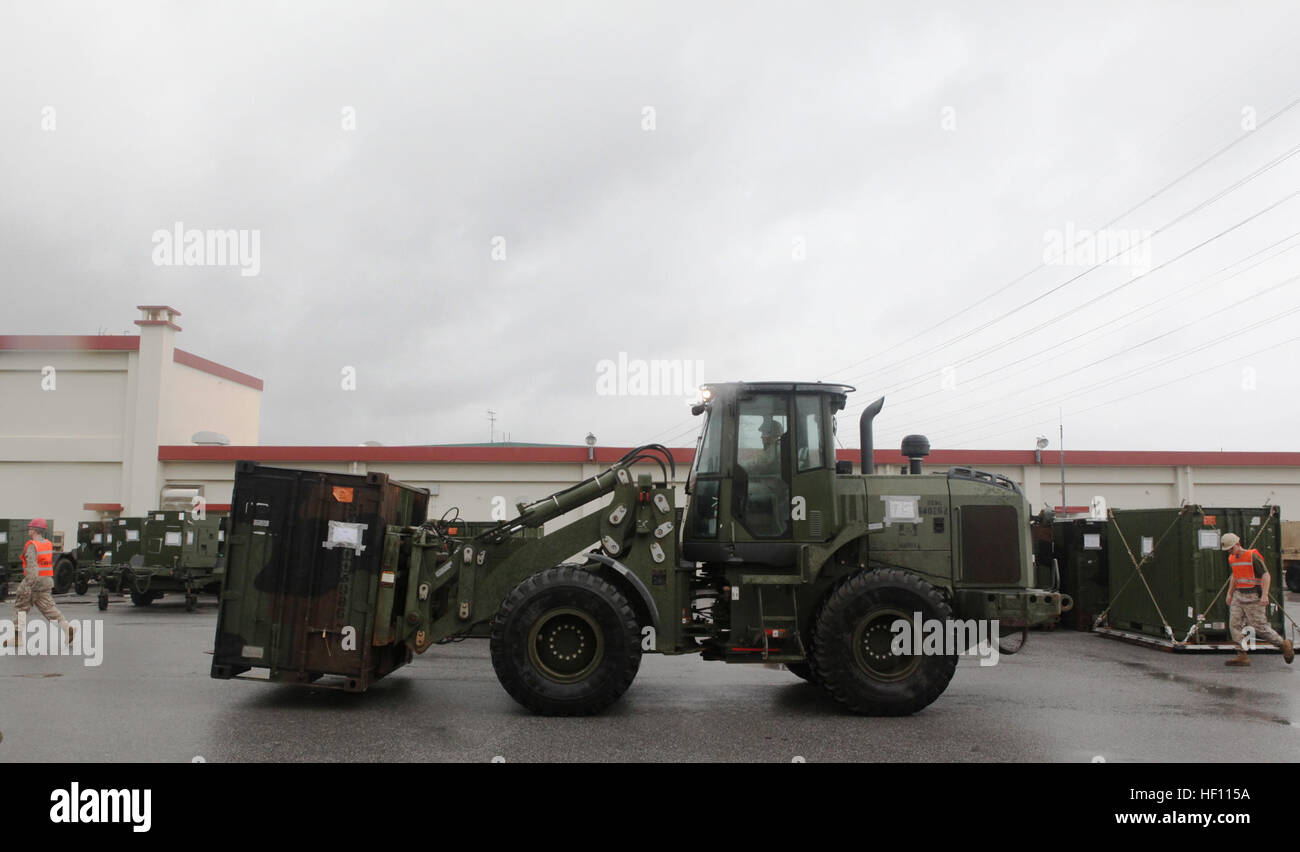 A forklift stages gear for a simulated deployment during a mobility ...