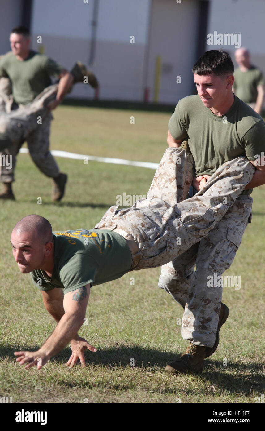 Two Marines race during a wheel-barrel competition at the 2nd ...
