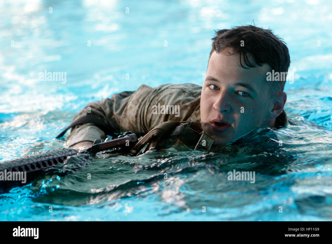 A Marine swims 50 meters with a full combat load during Marine Corps ...