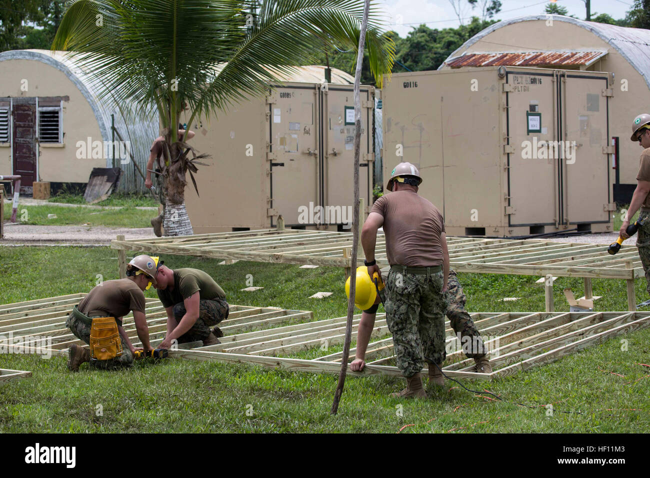 U.S. Navy Seabees and Marines construct decks to provide support for ...